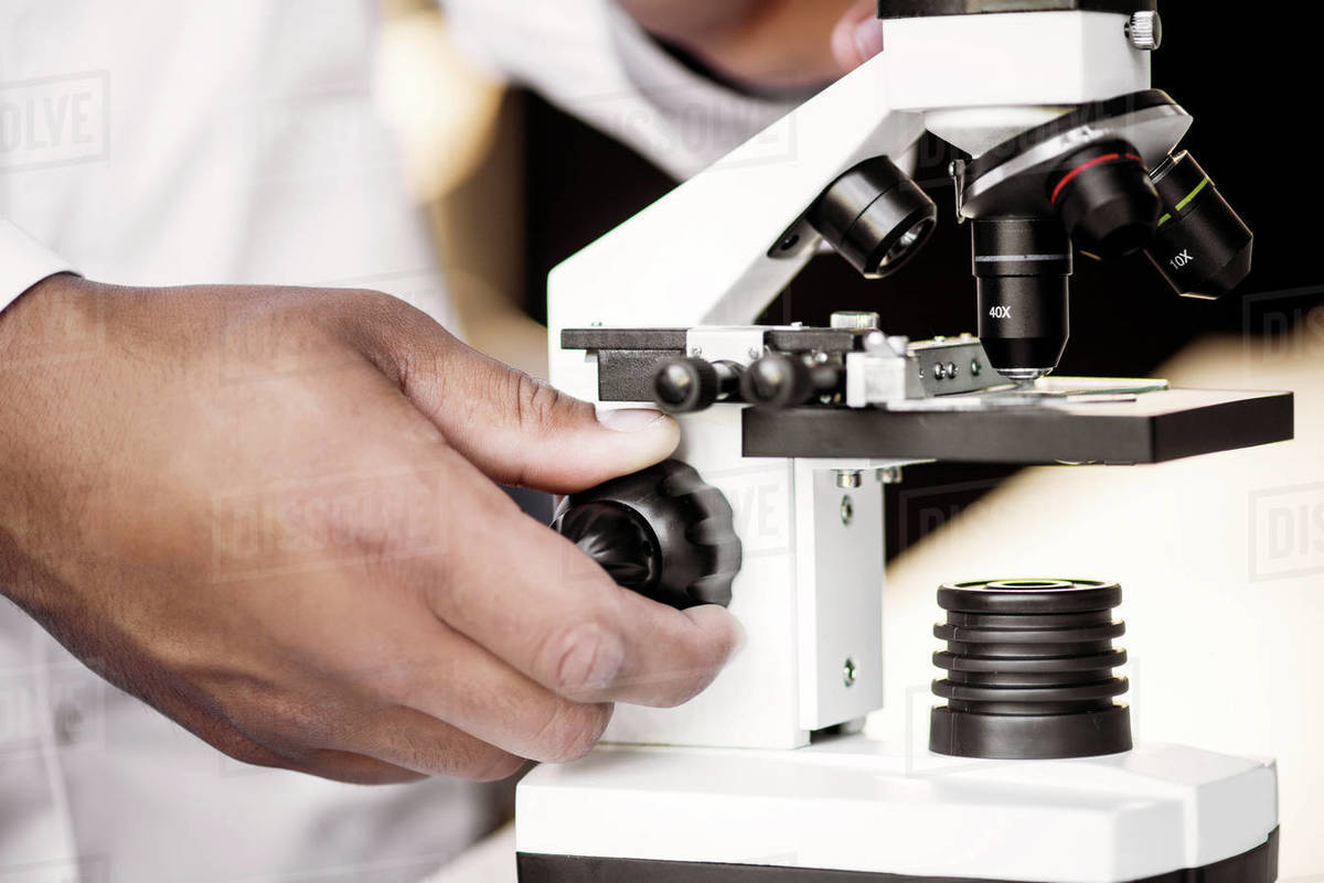 Cropped shot of a lab worker using a microscope - Royalty-free Stock ...
