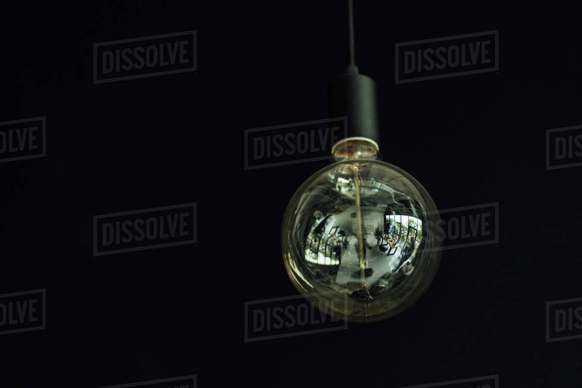 Vintage hanging Edison light bulb on black background - Stock Photo ...