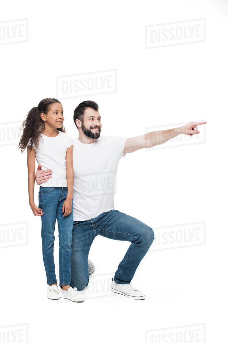 Smiling father pointing away with little daughter near by isolated on ...