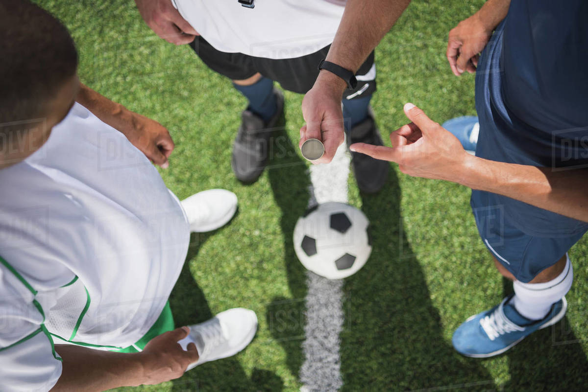 Cropped shot of referee holding coin before start of soccer match on ...