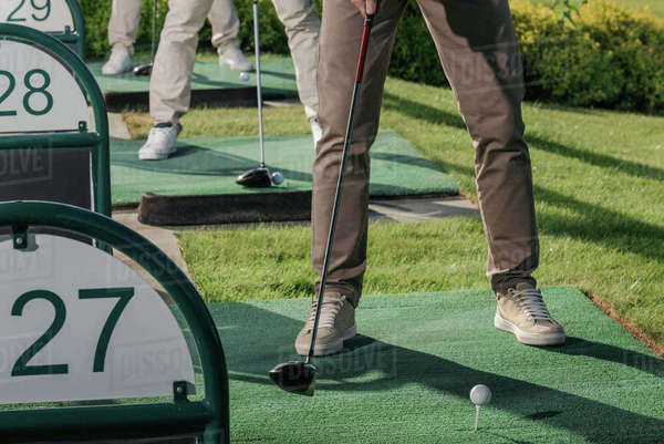 Cropped shot of group of golf players playing golf together at golf ...