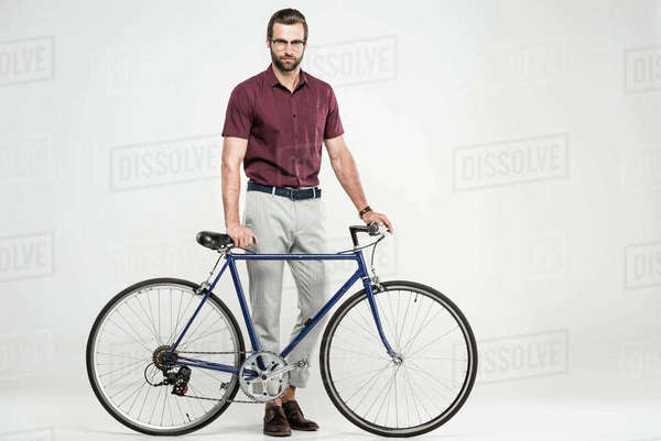 Stylish man posing with bike, isolated on grey - Royalty-free Stock ...