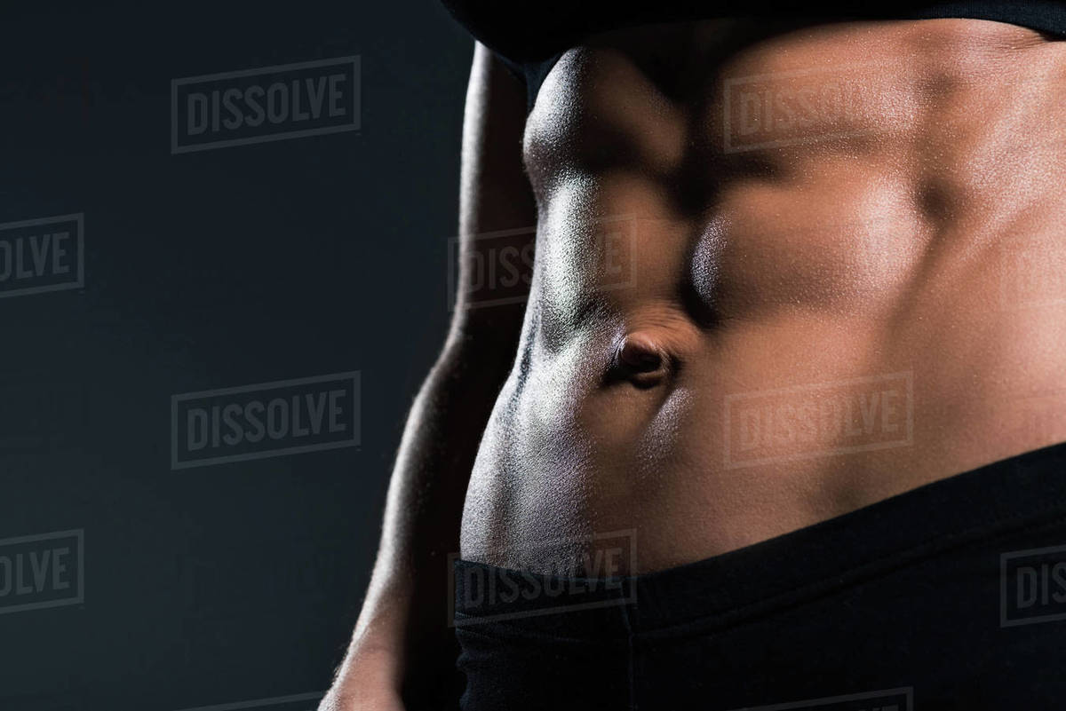 Partial view of sexy female bodybuilder with muscular abs, isolated on ...