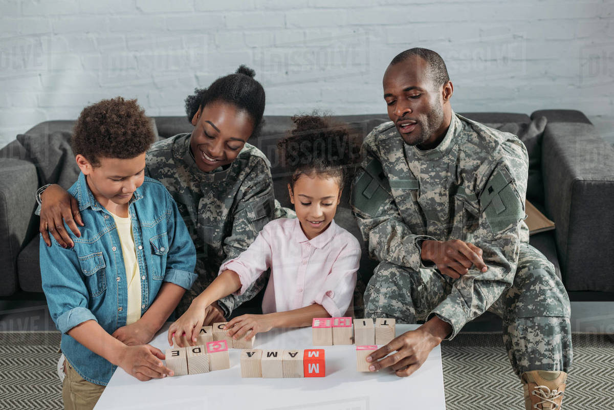 Army soldiers with happy kids playing words game - Stock Photo - Dissolve