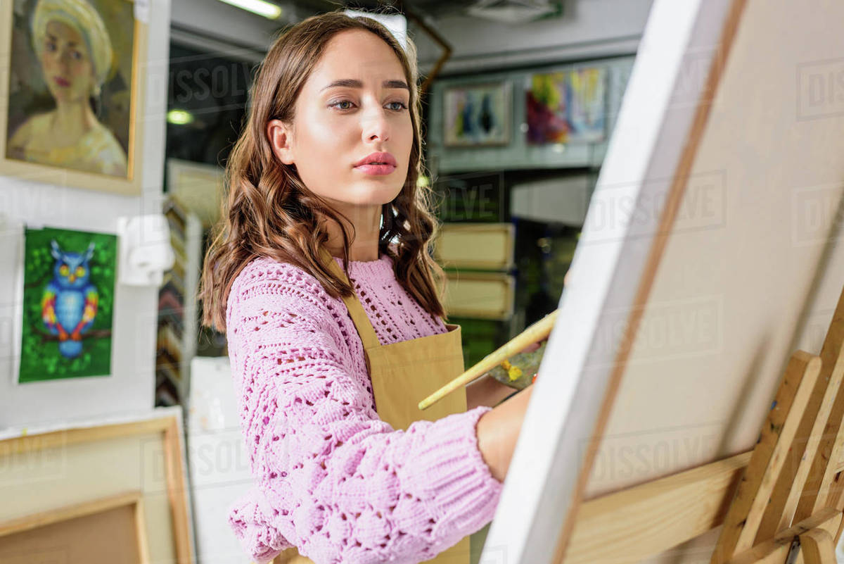 Attractive female artist painting in workshop - Royalty-free Stock ...