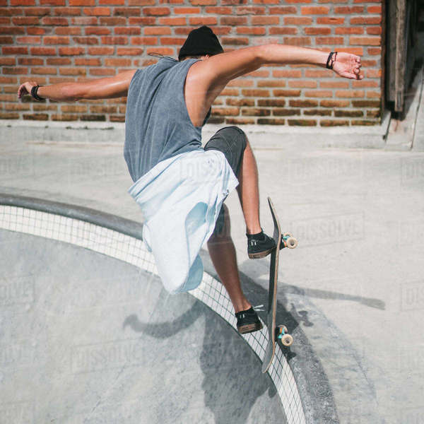 Back view of skater jumping with longboard - Royalty-free Stock Photo ...