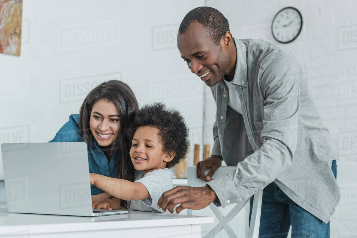 African american parents and son using laptop at home - Royalty-free ...