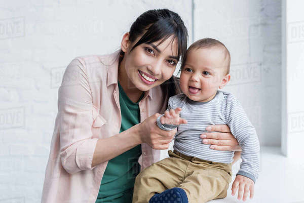 Young happy mother and little child looking at camera - Royalty-free ...