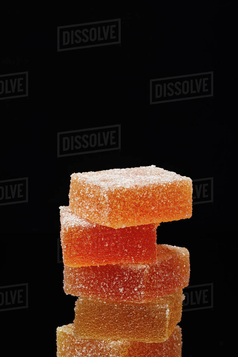 Close-up shot of stack of jelly candies isolated on black background ...