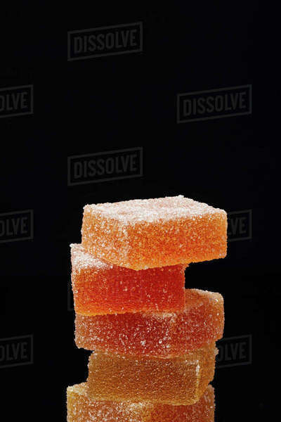 Close-up shot of stack of jelly candies isolated on black background ...