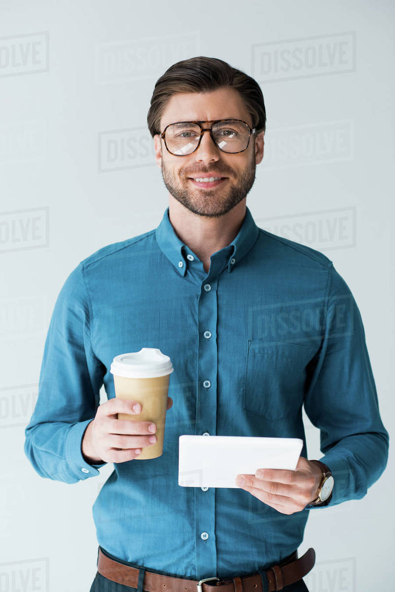 Happy young man with paper cup of coffee and tablet isolated on white ...