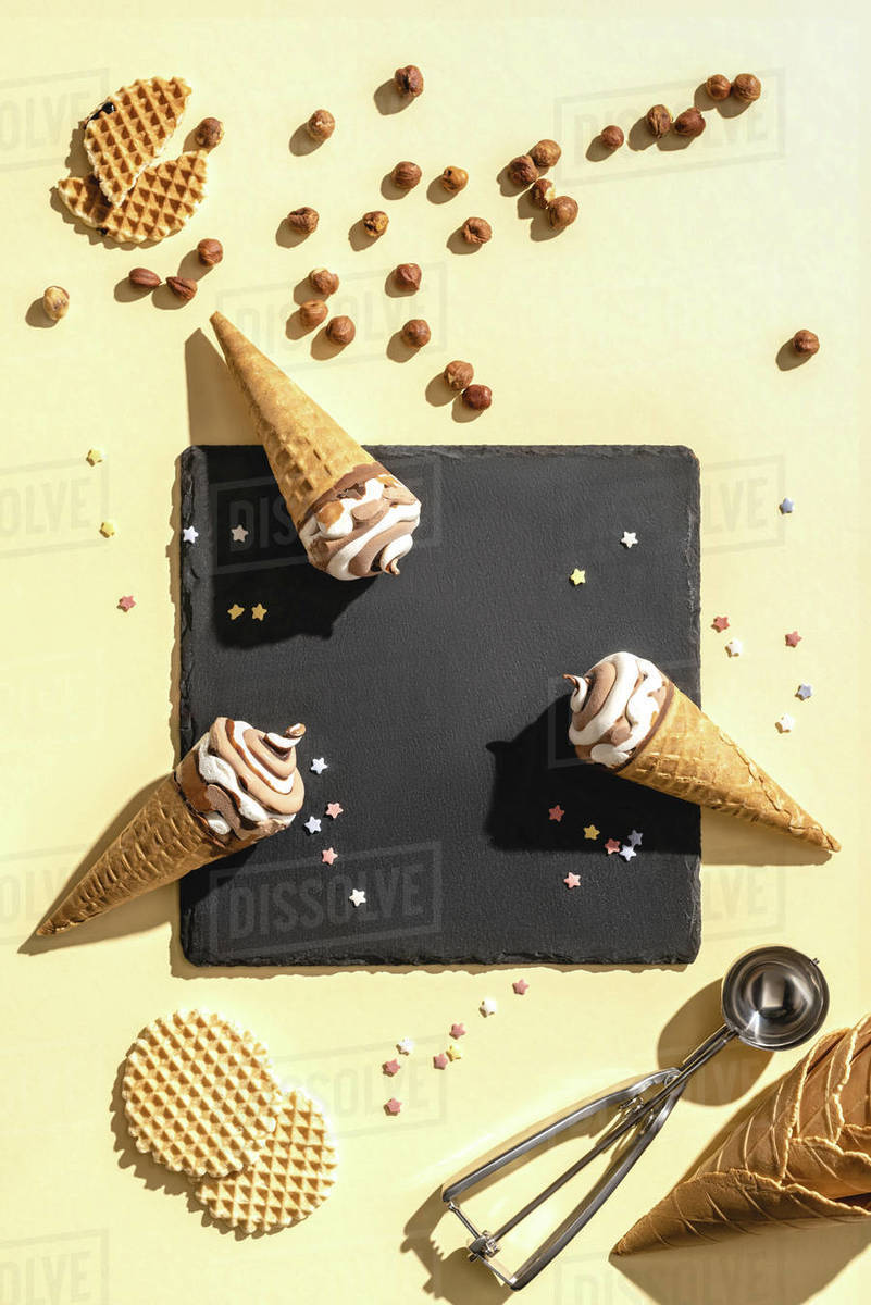 top view of three ice cream on yellow - Stock Photo - Dissolve