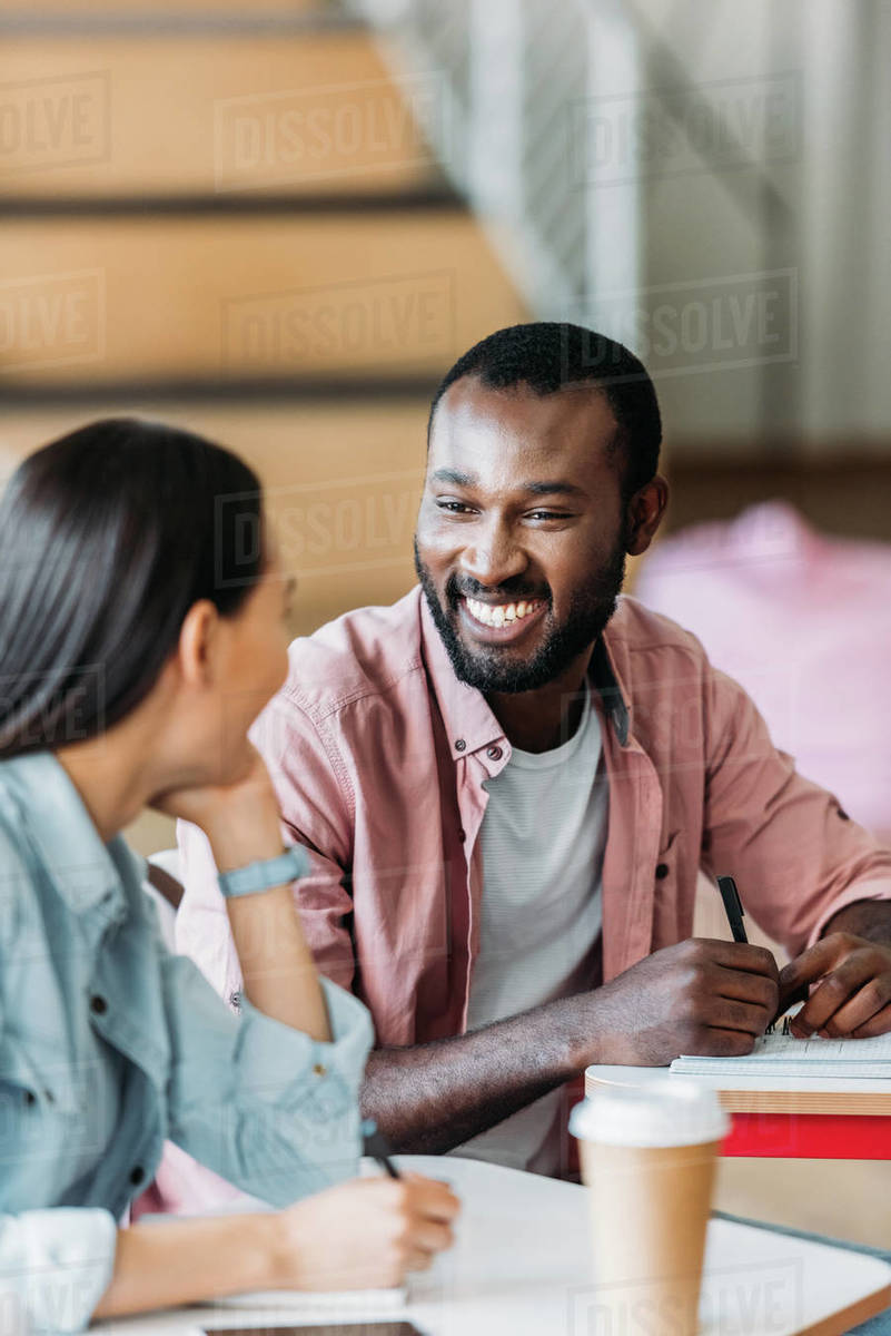 Multiethnic young students chatting at classroom of college - Stock ...