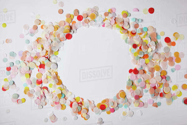 Top view of circle of colored confetti pieces on white surface - Stock ...
