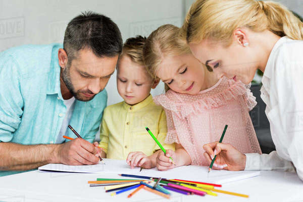Happy family drawing with colored pencils together at home - Royalty ...