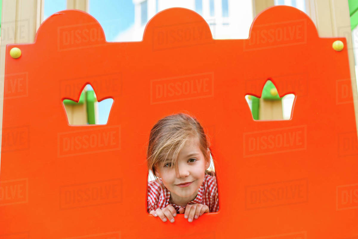 Portrait of adorable smiling little kid looking at camera at playground ...