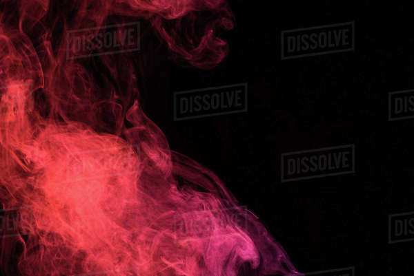 Red smoke on black background with copy space - Stock Photo - Dissolve