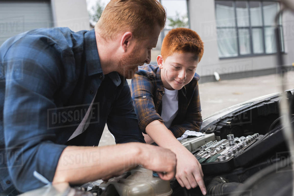 father and son repairing car with open hood together - Royalty-free ...