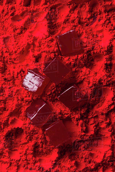 top view of scattered candies on red powder - Royalty-free Stock Photo ...