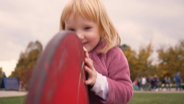CU of a little girl going up and down on a swing in slow motion - Stock ...