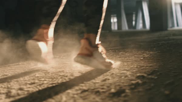 Running quick steps raising dust particles from the floor shimmering in ...