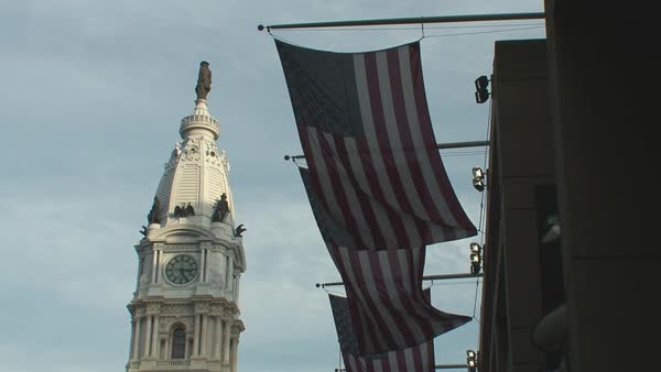 Close up of the clock tower at the Philadelphia City Hall with American ...