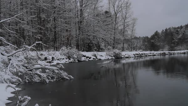 Snow falls over a lake and forest. - HD Rights-managed Stock Video ...