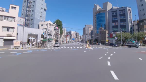 A pov of driving cityscape on the city street in Tokyo in summer wide ...