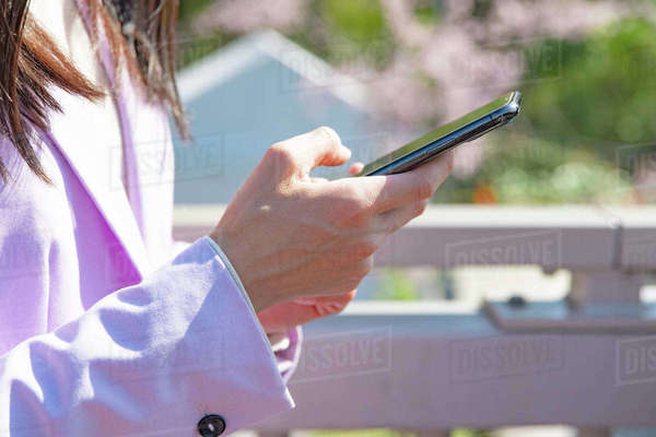Body parts of hands using smartphne by Japanese woman at the street ...