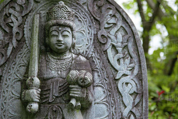 A religious stone statue of Akasagarbha at Japanese buddhism temple ...