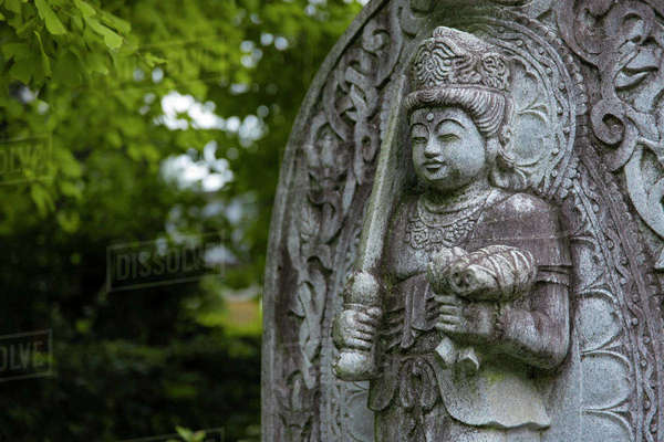A religious stone statue of Akasagarbha at Japanese buddhism temple ...