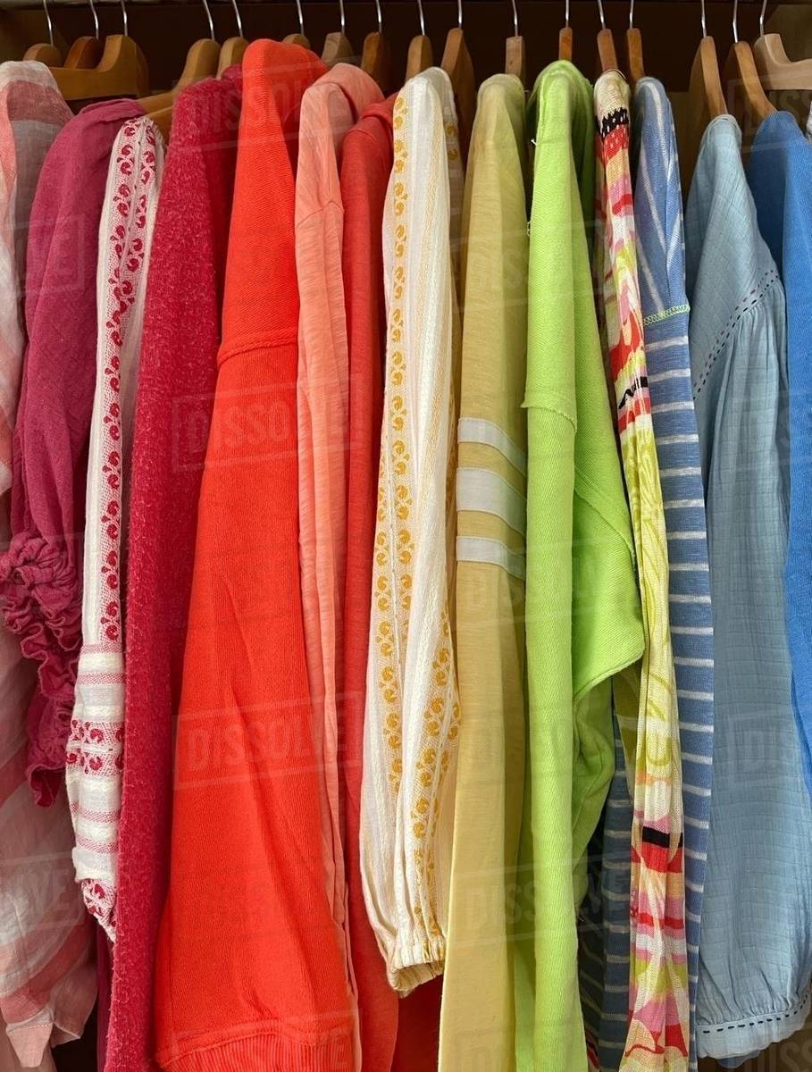 Close-up of a rainbow coloured clothes hanging in a wardrobe - Royalty ...