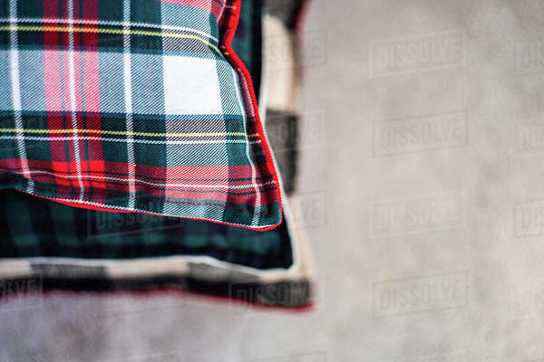 Close-up of a stack of assorted pillows with various checked patterns ...