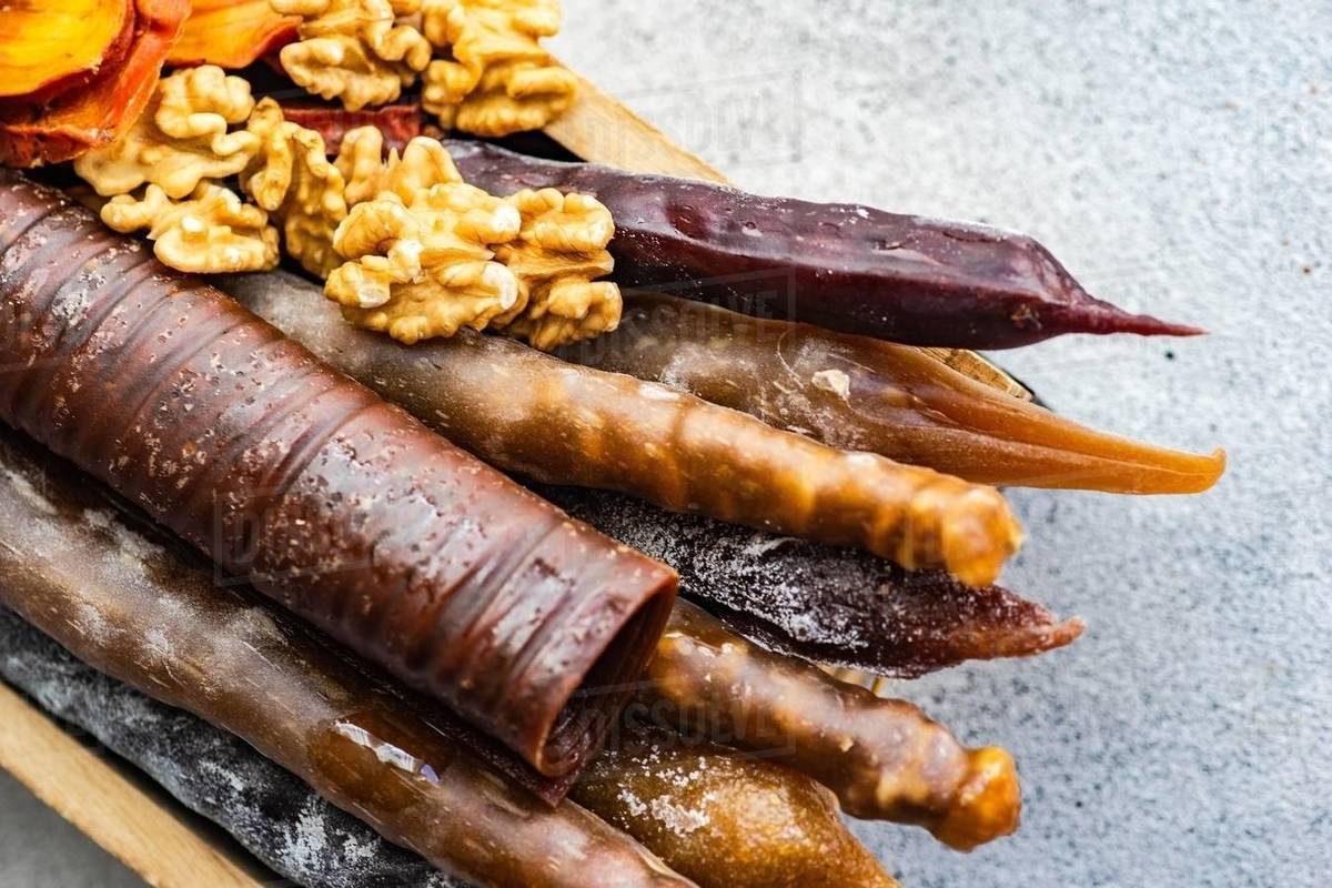 Traditional Georgian churchkhela, tklapi and gozinaki with assorted ...