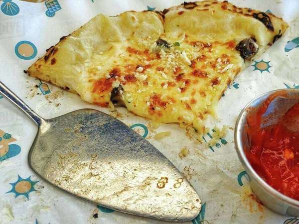 Close-up of two slices of pizza with tomato dipping sauce - Stock Photo ...