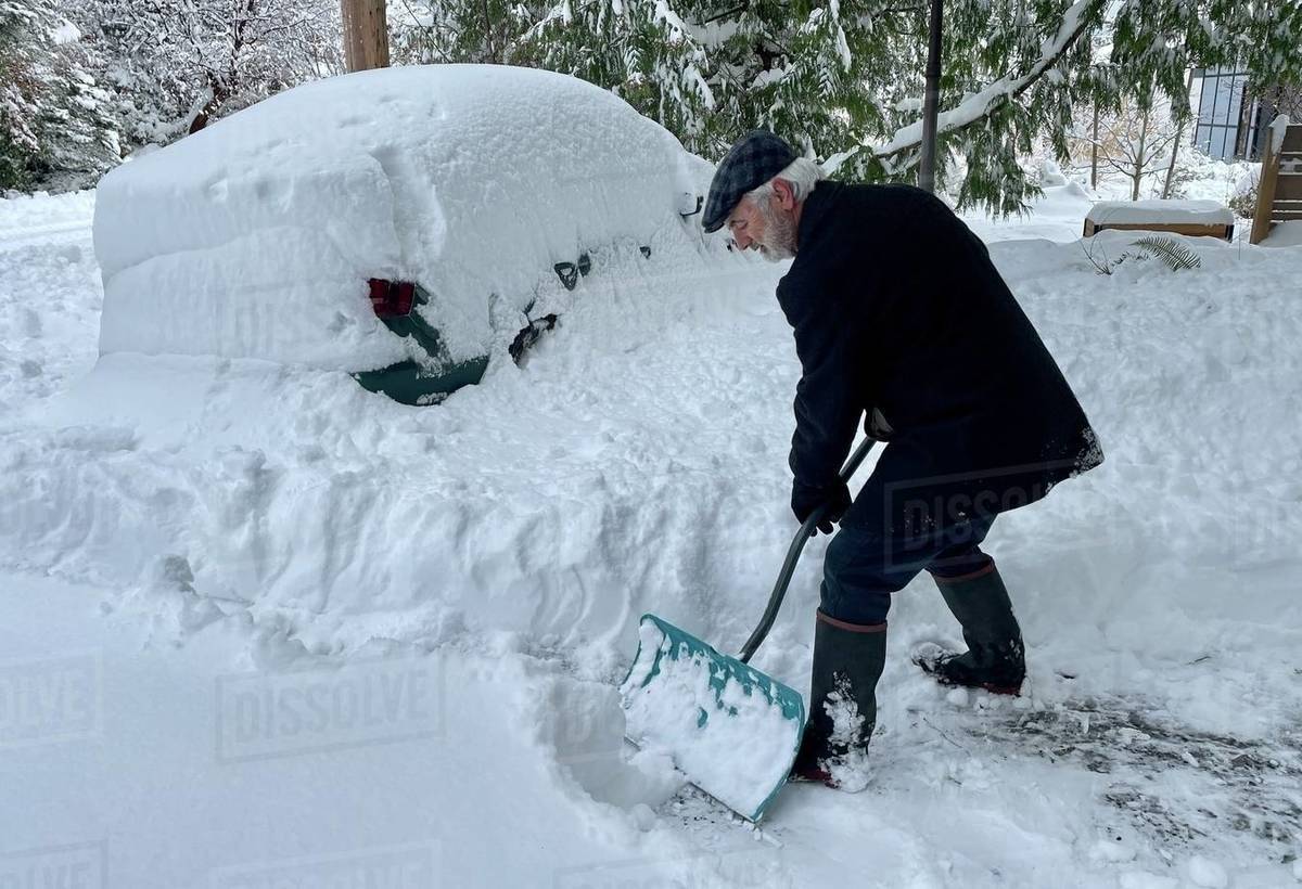 Senior Man Shoveling Snow in a driveway by his car, British Columbia ...