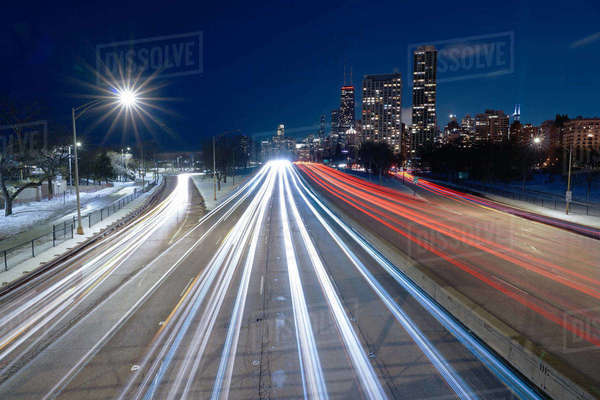 City skyline and Light trails on Lake Shore Drive at night, Chicago ...