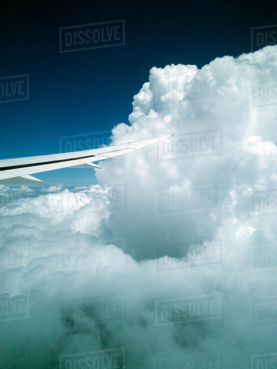 Aircraft wing in flight through clouds - Stock Photo - Dissolve