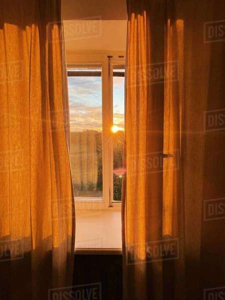 Sunrise through a window with half opened curtains - Royalty-free Stock ...
