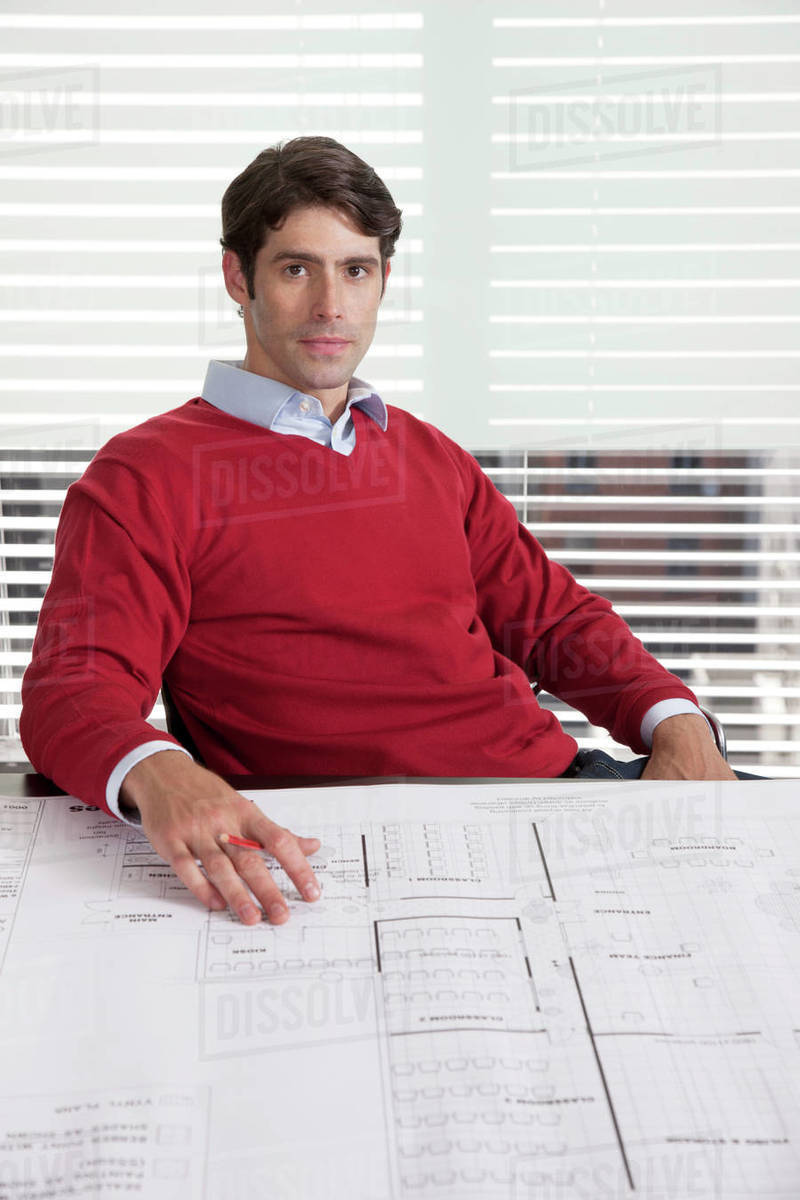 Portrait of architect sitting at desk with plans - Royalty-free Stock ...