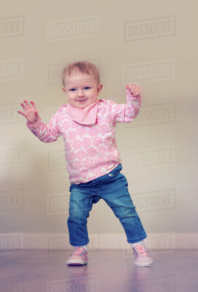 Baby girl taking her first steps - Royalty-free Stock Photo | Dissolve