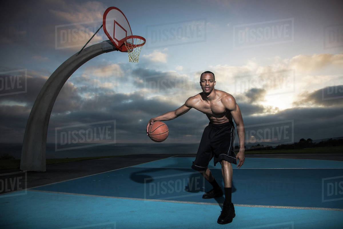 Young man playing basketball in a park, Los Angeles, California, USA ...