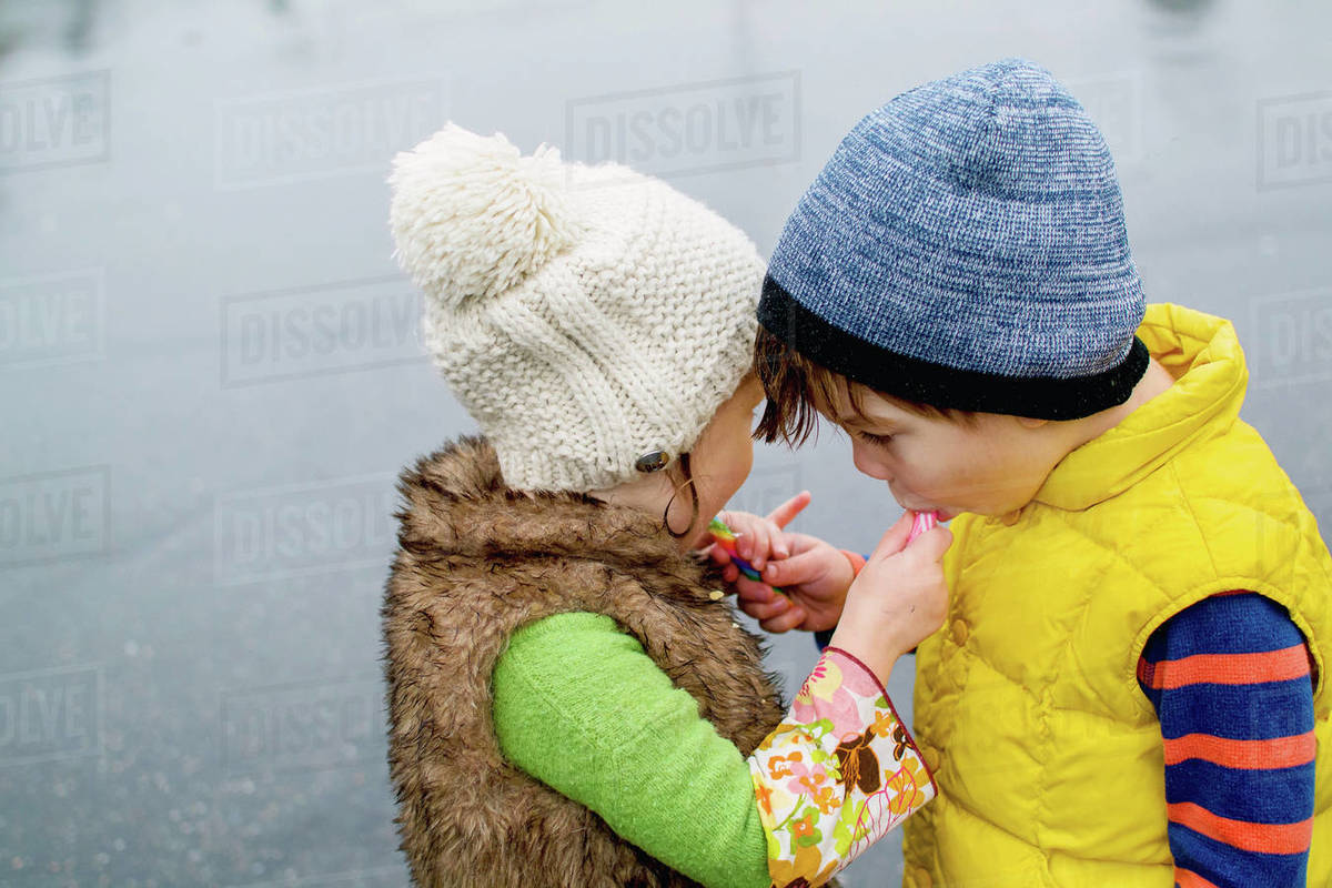 Boy and girl sharing sweets - Royalty-free Stock Photo | Dissolve