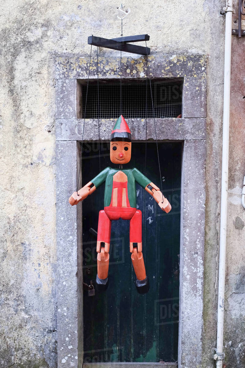 Traditional wooden puppet hanging outdoors - Royalty-free Stock Photo ...