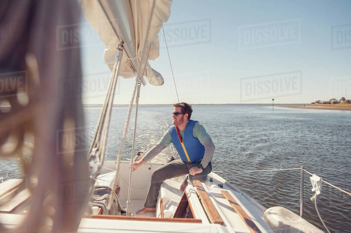 Man sailing sailboat, Florida, America, USA - Stock Photo - Dissolve