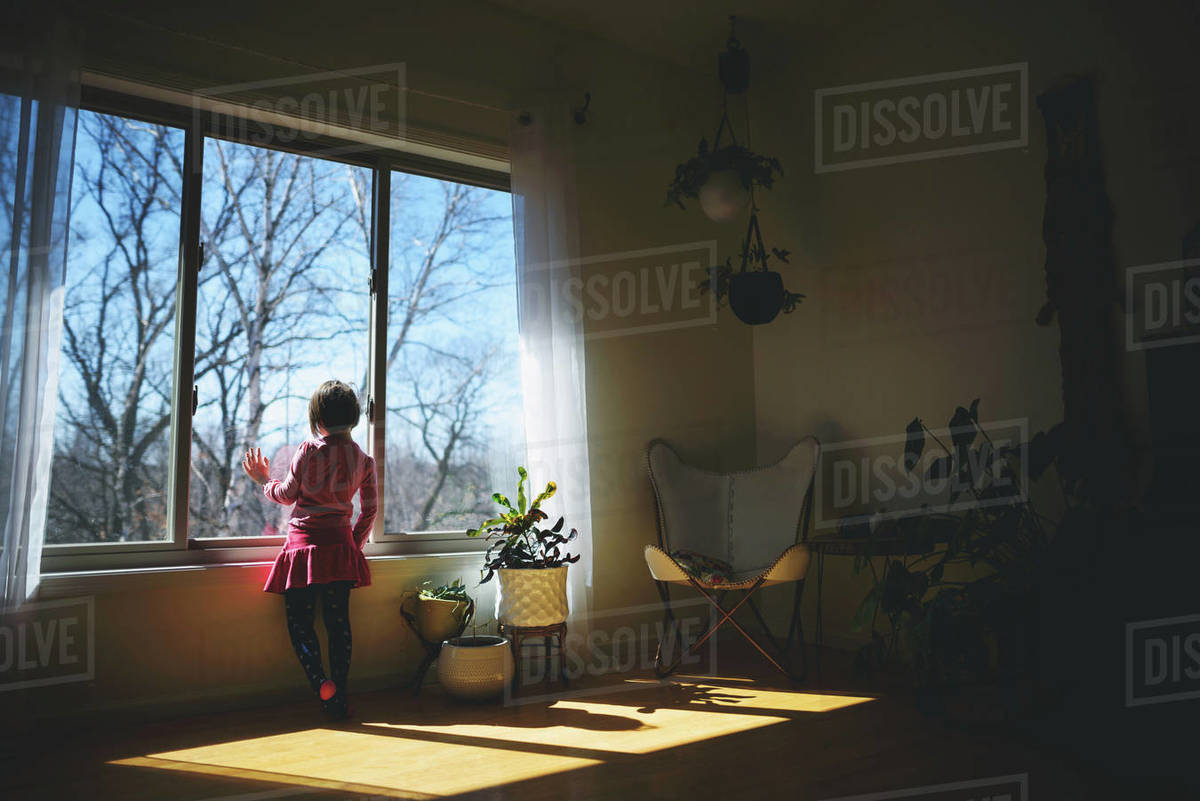 Girl looking through a window - Royalty-free Stock Photo | Dissolve