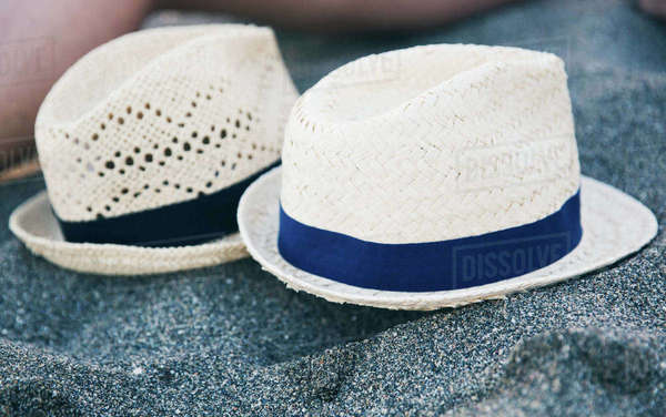 Two hats on a rock - Stock Photo - Dissolve