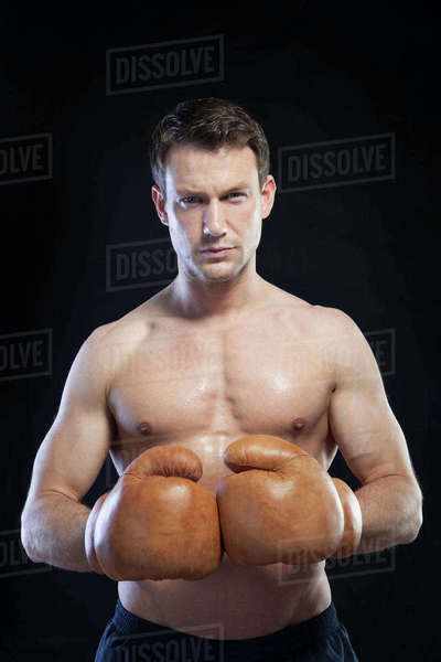 Boxer looking serious in studio - Royalty-free Stock Photo | Dissolve