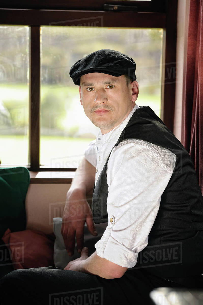 Man sitting at window. - Stock Photo - Dissolve