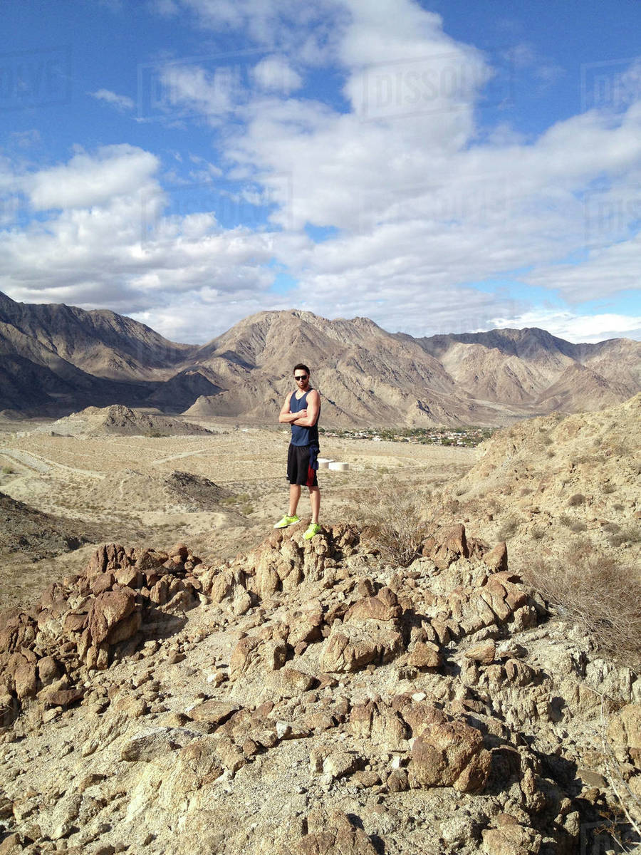 Man on mountaintop overlooking valley below - Royalty-free Stock Photo ...